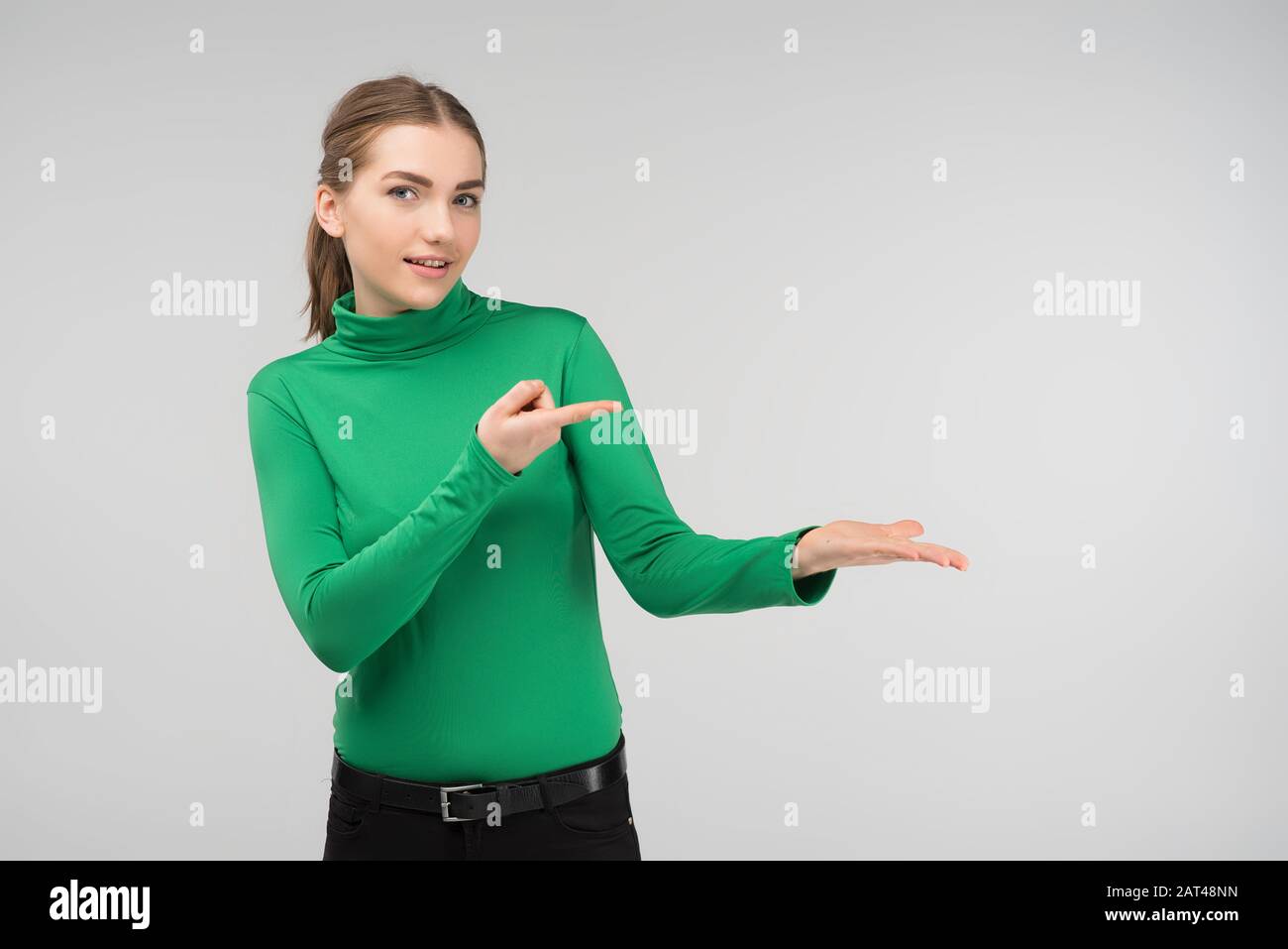 Young girl stands in surprise points out Stock Photo - Alamy
