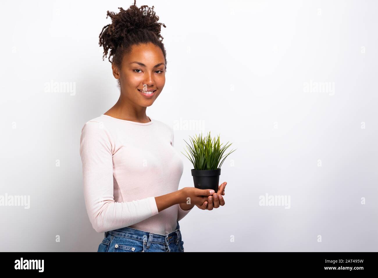 Half-turn portrait girl with grass pot in her hands. Concept World ...