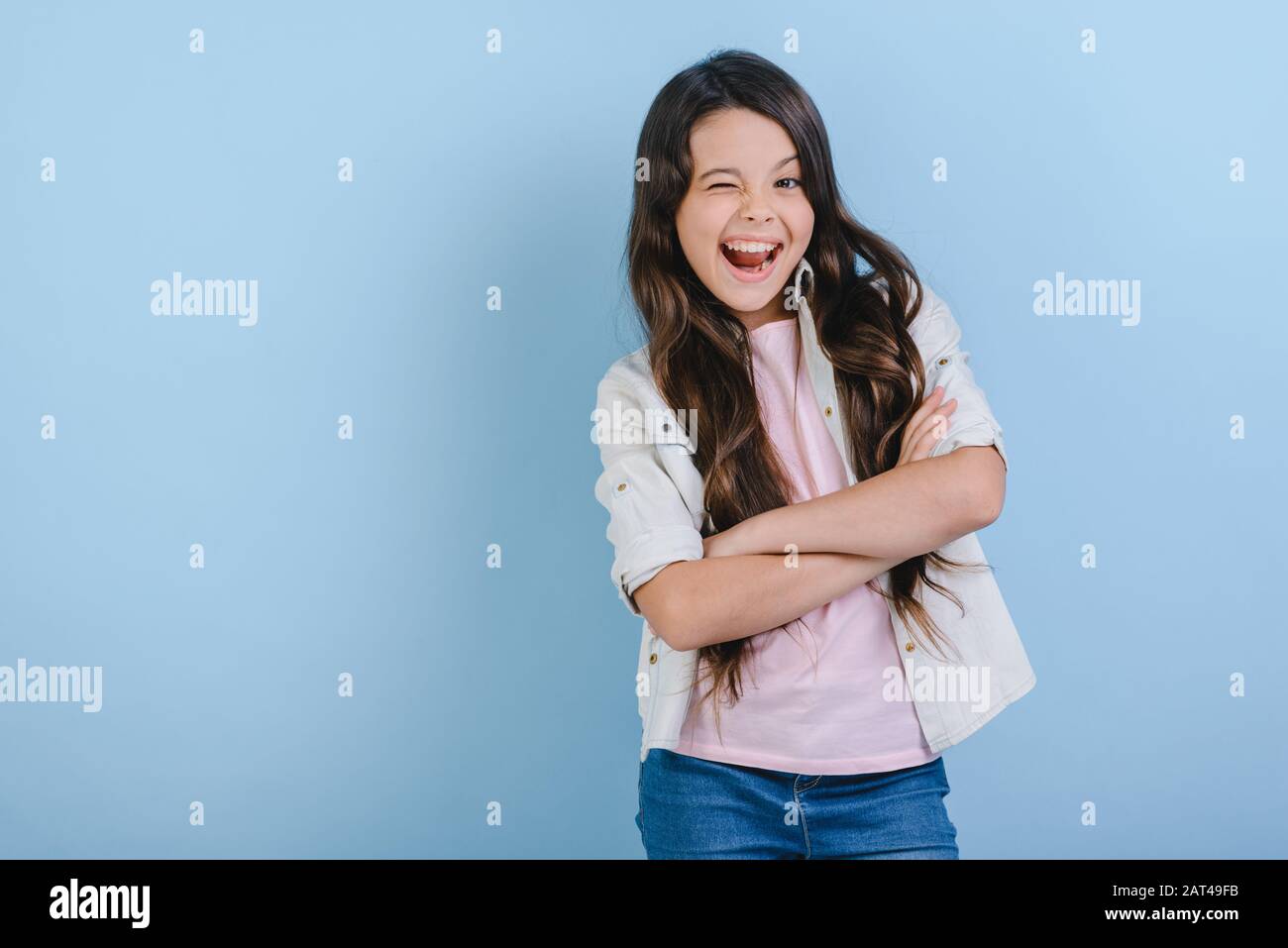 Studio portrait of happy girl winks. - Image Stock Photo - Alamy