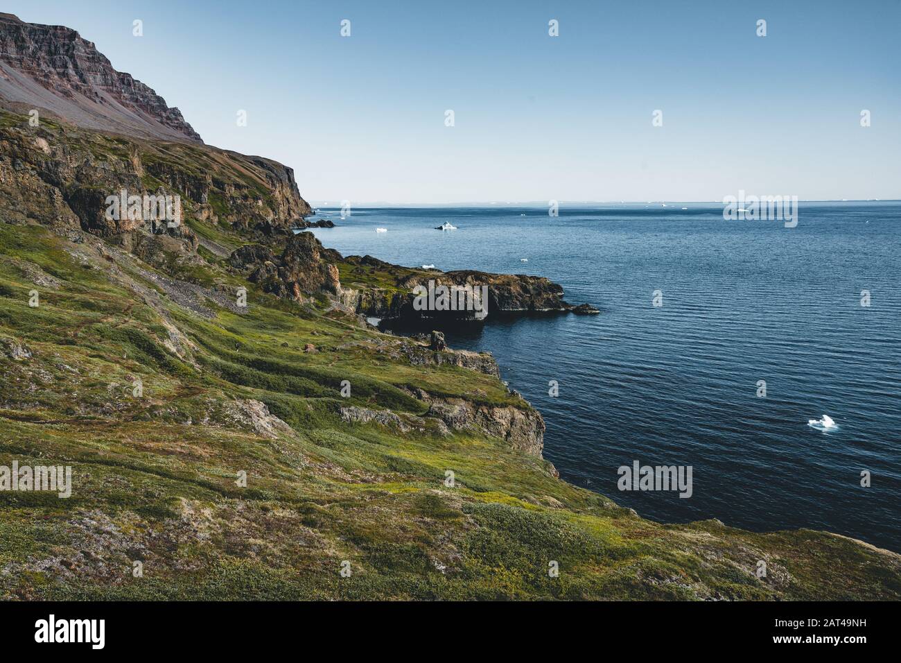 Arctic Beach with small waterfall in Greenland. Near small village of ...