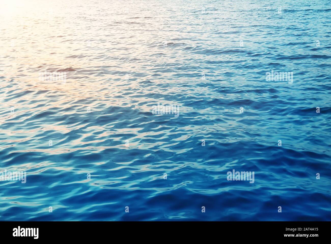 Dark blue water surface with sunset light redlection. Sea or ocean ...