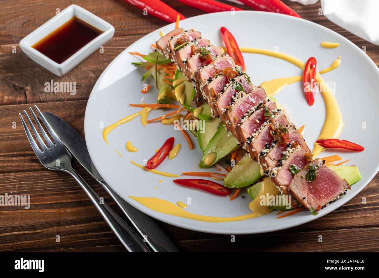 Japanese food. Tataki with tuna. Fried fish with sesame seeds and soy ...