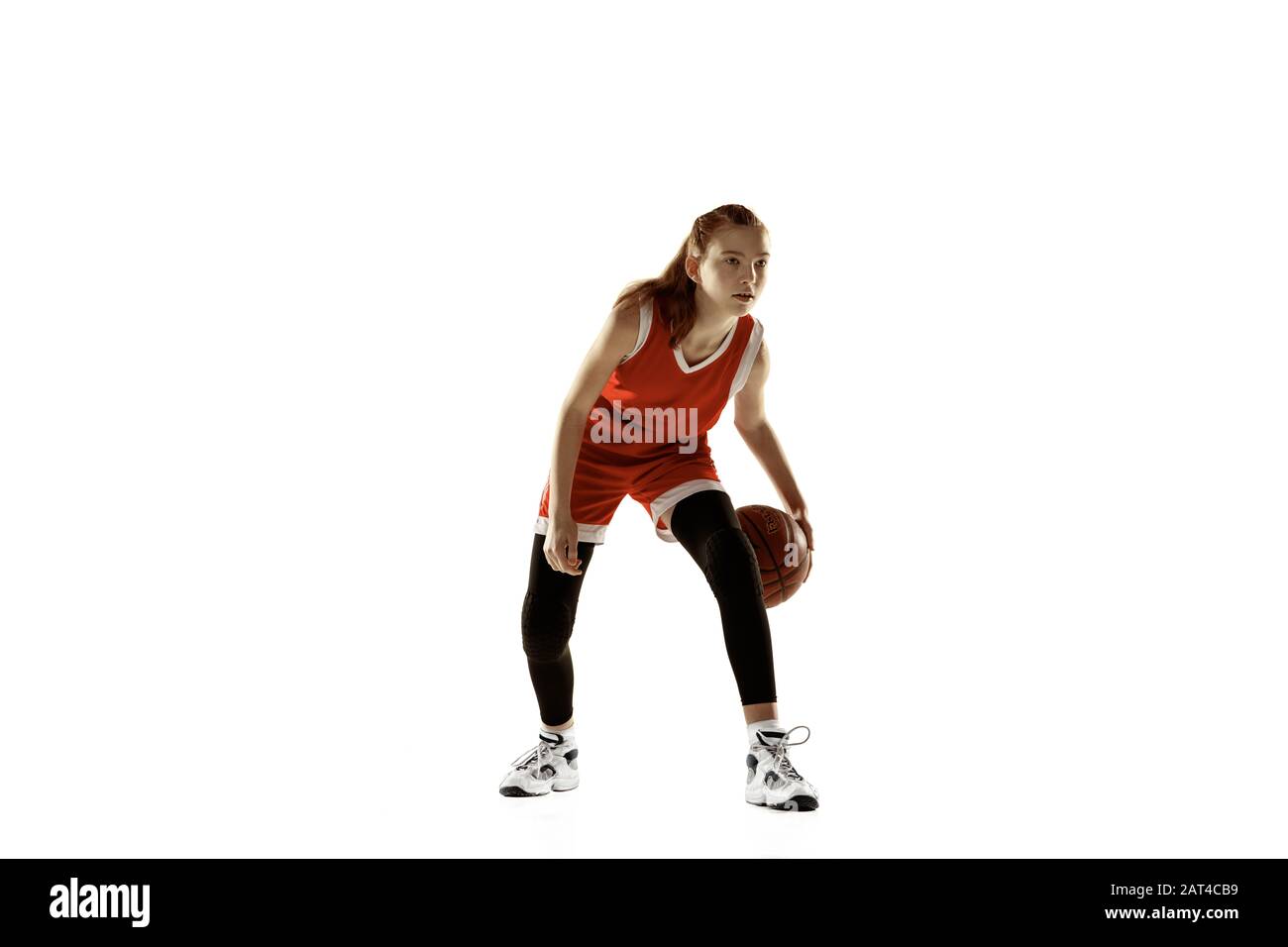 Young caucasian female basketball player in action, motion in run ...