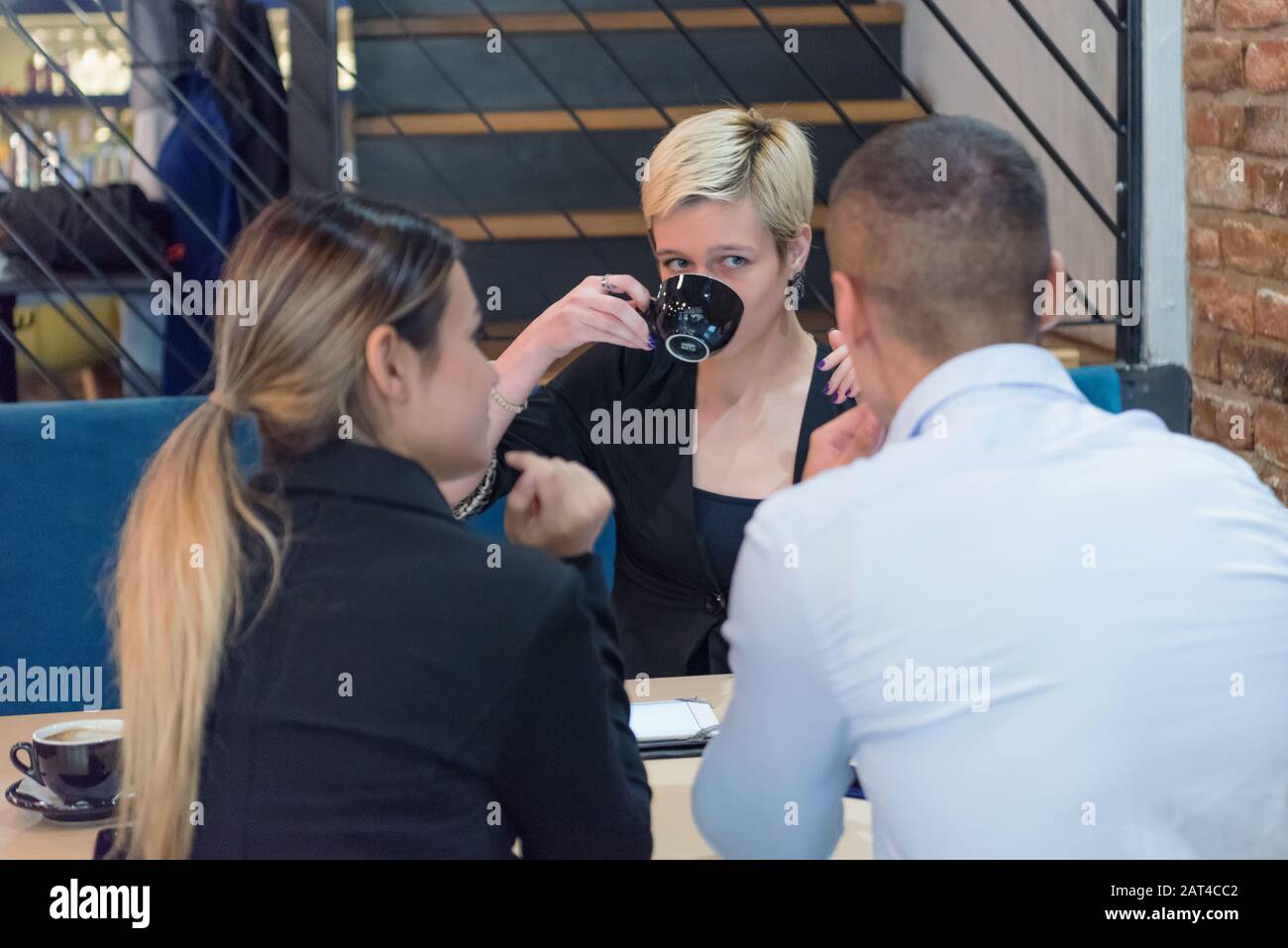 Full concentration at work. Group of young business people working and ...