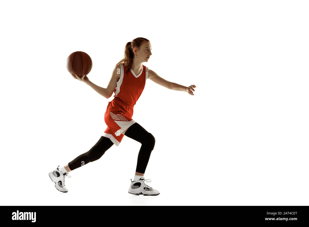 Young caucasian female basketball player in action, motion in run ...