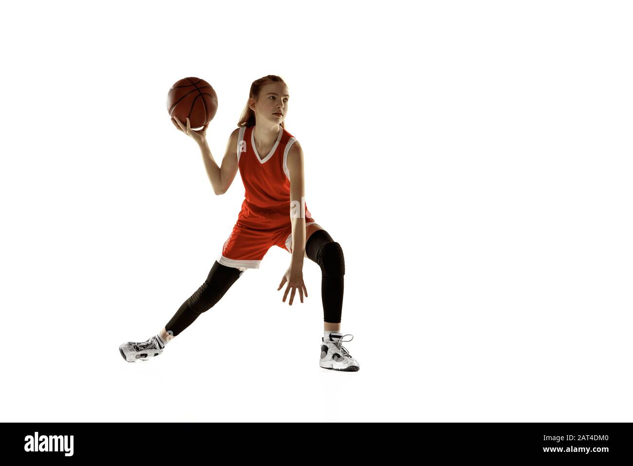 Young caucasian female basketball player in action, motion in run ...