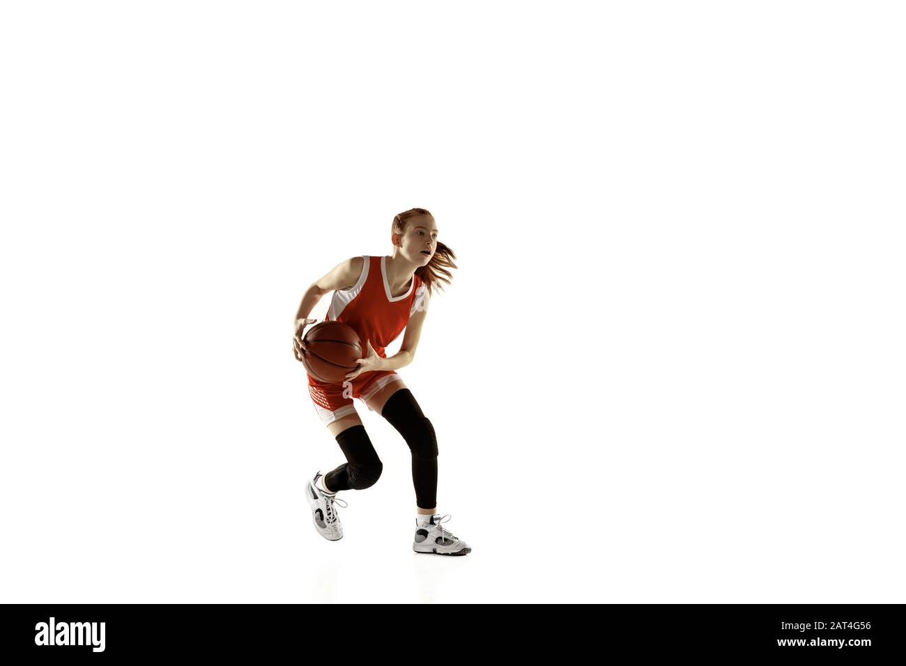 Young caucasian female basketball player in action, motion in run ...