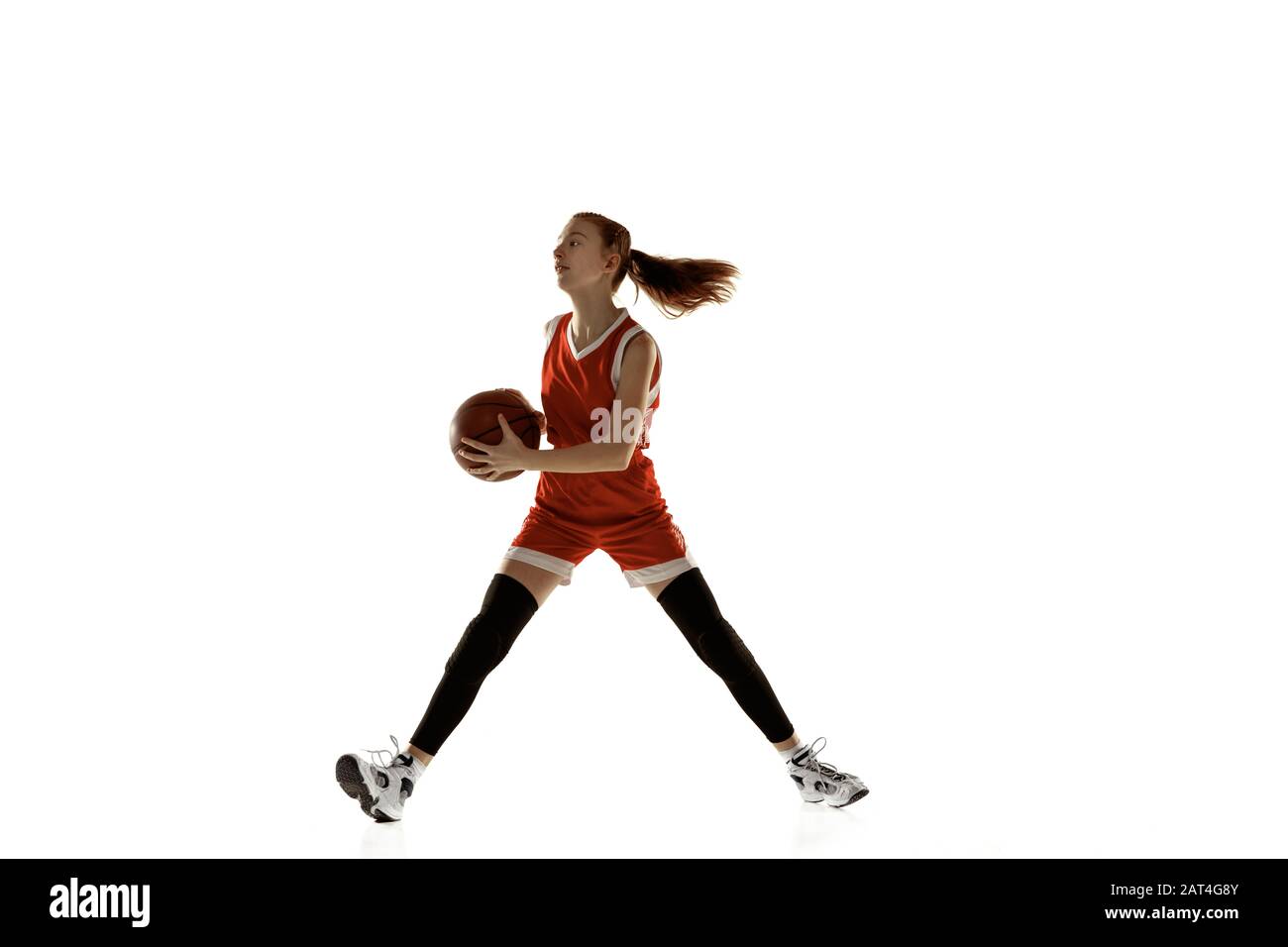 Young caucasian female basketball player in action, motion in run ...