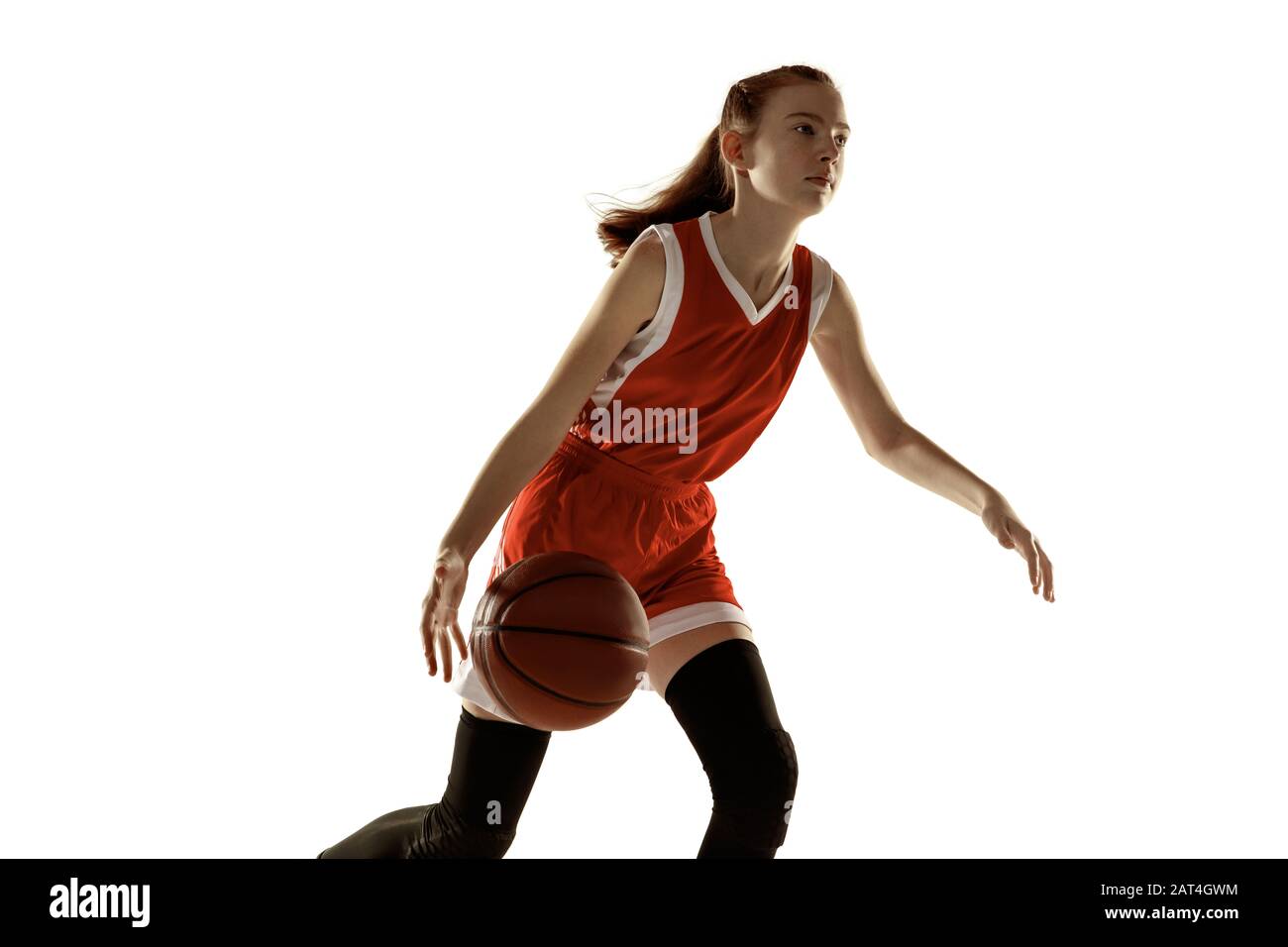 Young caucasian female basketball player in action, motion in run ...