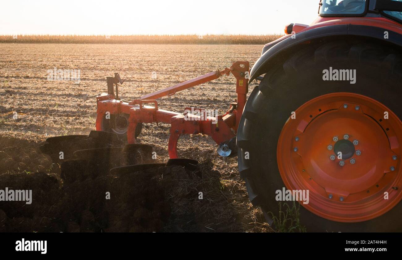 Tractor plowing fields -preparing land for sowing Stock Photo - Alamy
