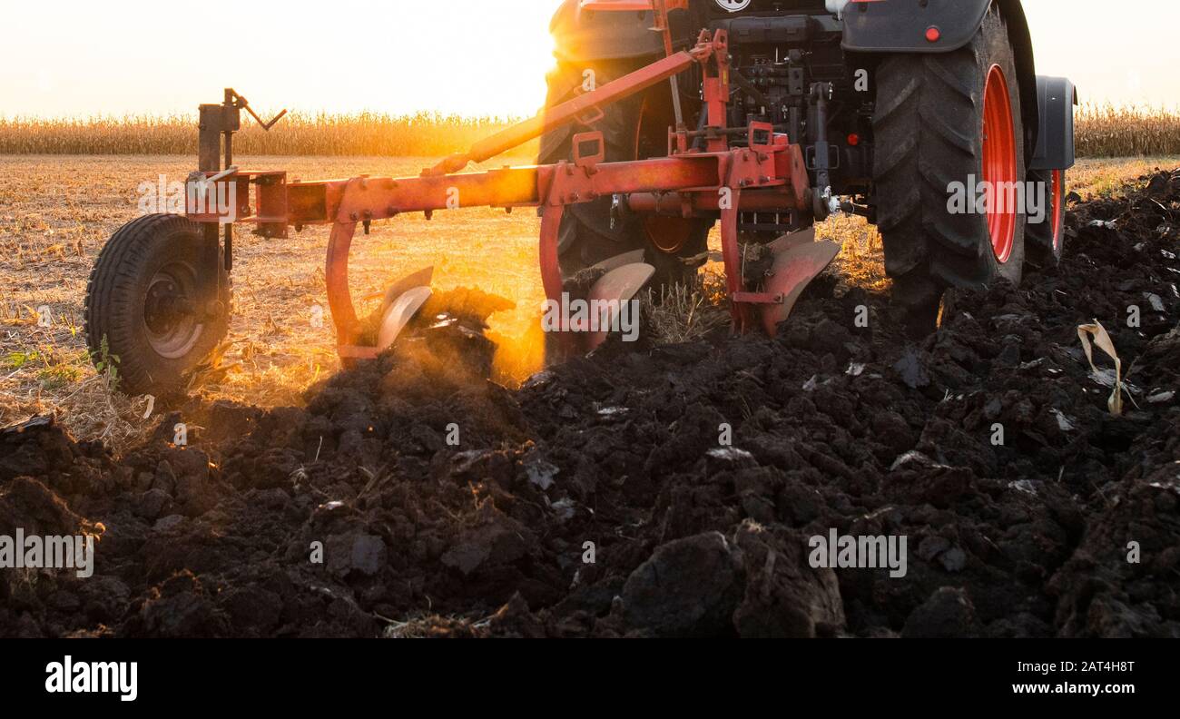 Tractor plowing fields -preparing land for sowing Stock Photo - Alamy