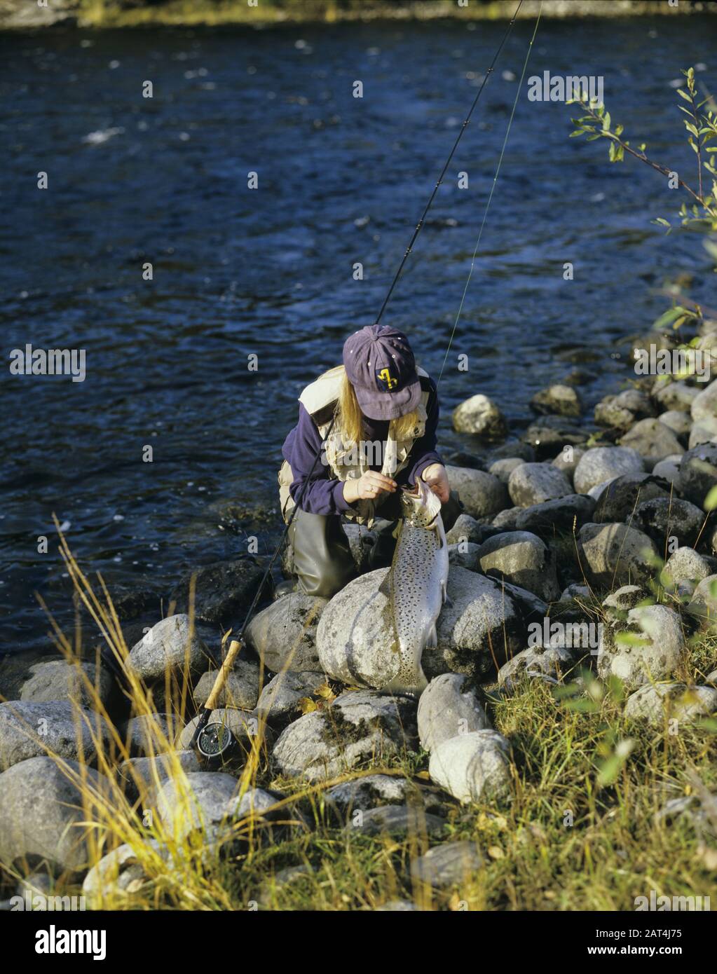 Woman with trout catch Stock Photo - Alamy