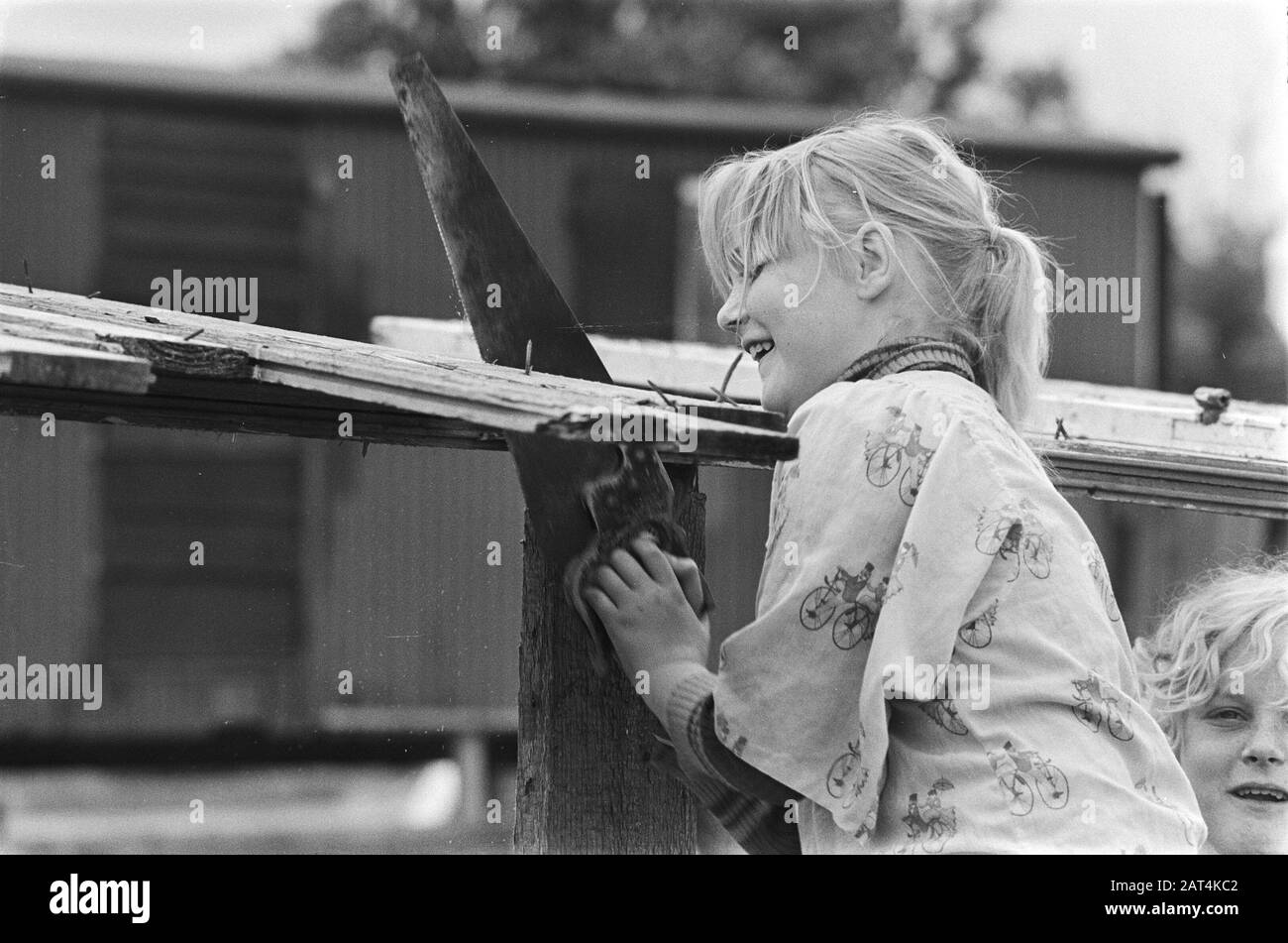 Youth plan North construction playground; girl with saw Date: 10 July ...