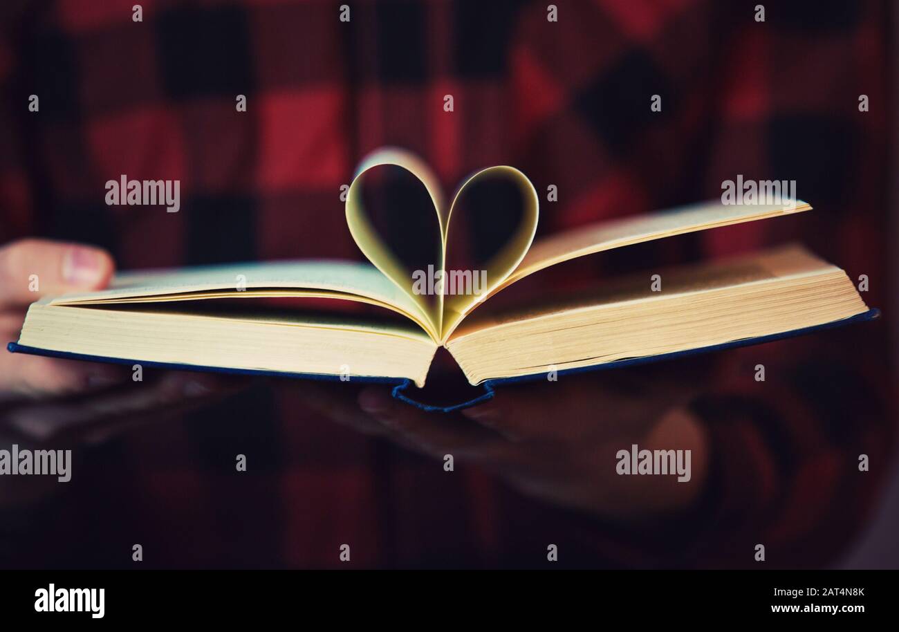Holding open textbook hi-res stock photography and images - Alamy