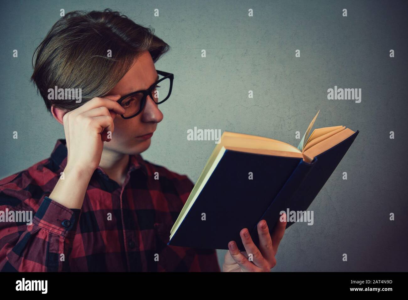 Close up portrait surprised student boy, fixing glasses, double check a ...