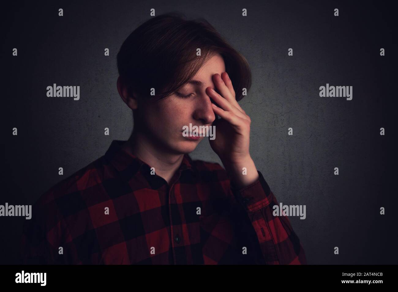 Distressed teenager boy mess in his head, pointing hand to forehead ...