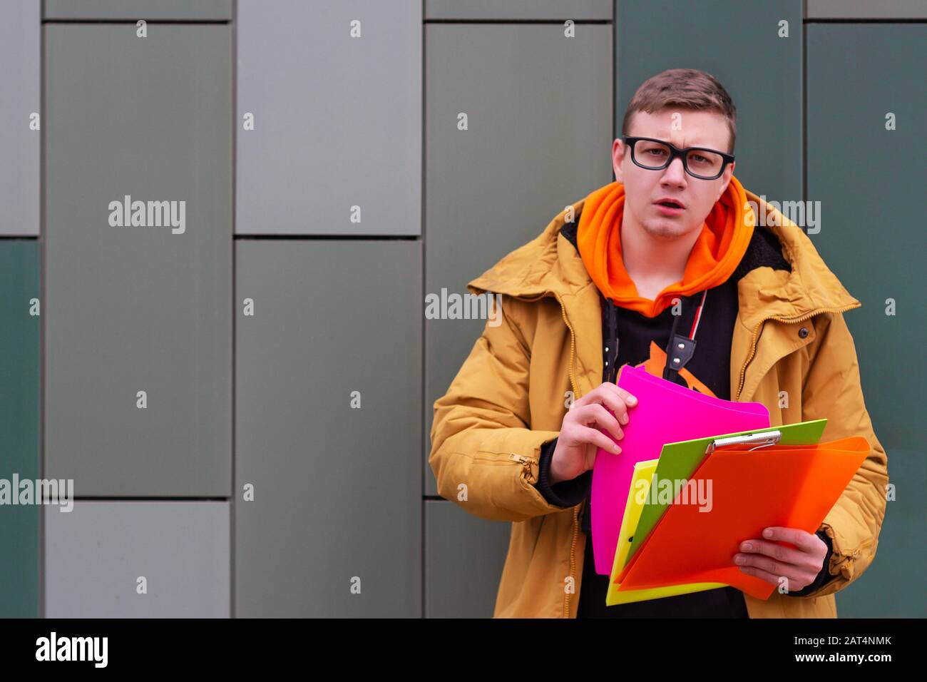 student guy holds books and asks straining your brain Stock Photo - Alamy