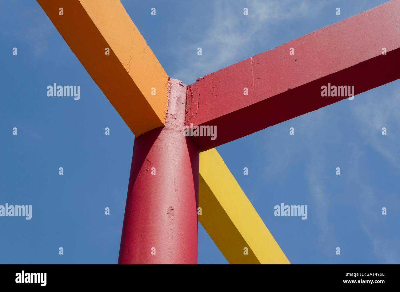 Girders of bright colors, red, orange and yellow, and blue sky, in La ...