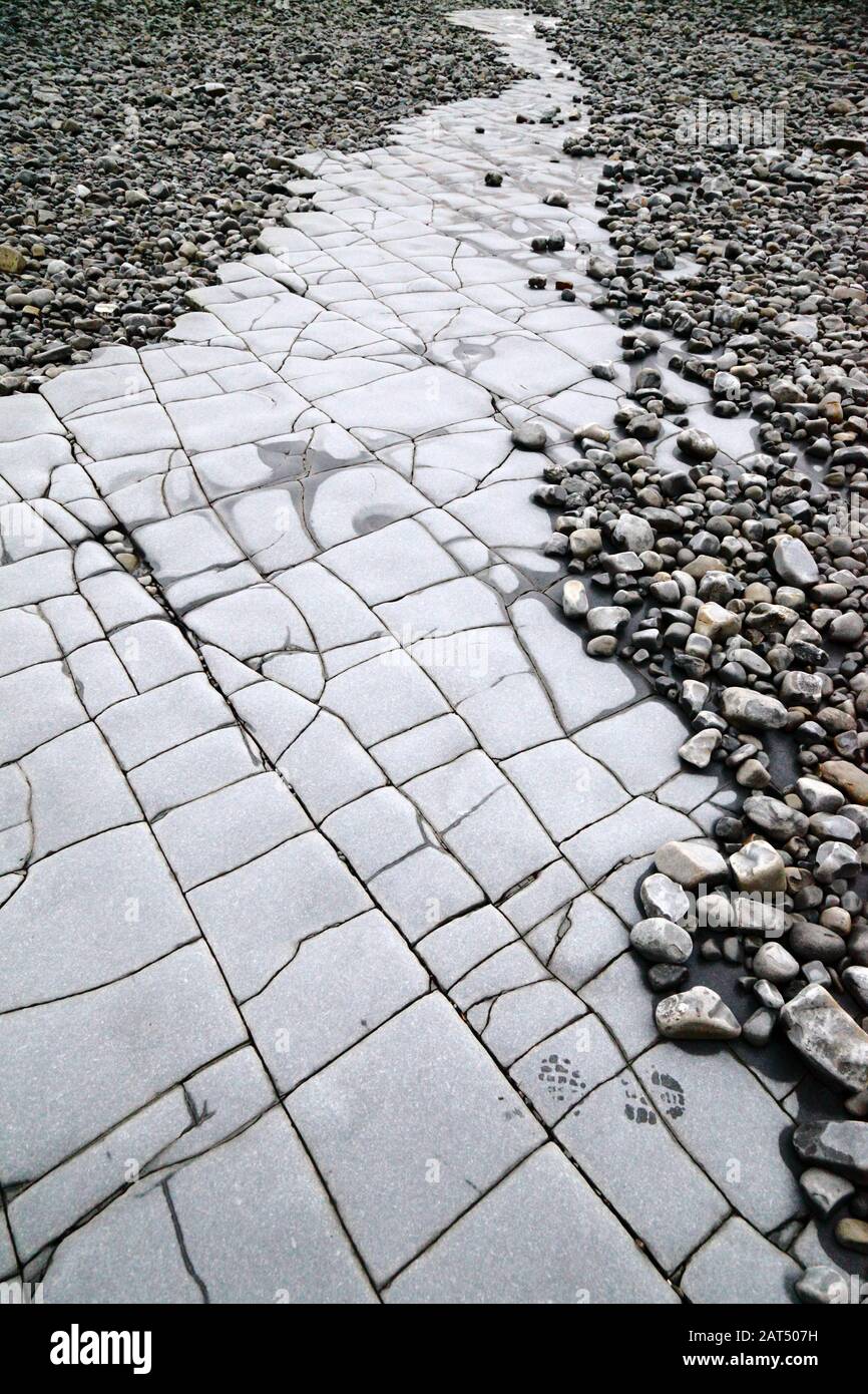 Limestone pavement and pebble beach on foreshore at Lavernock Point ...