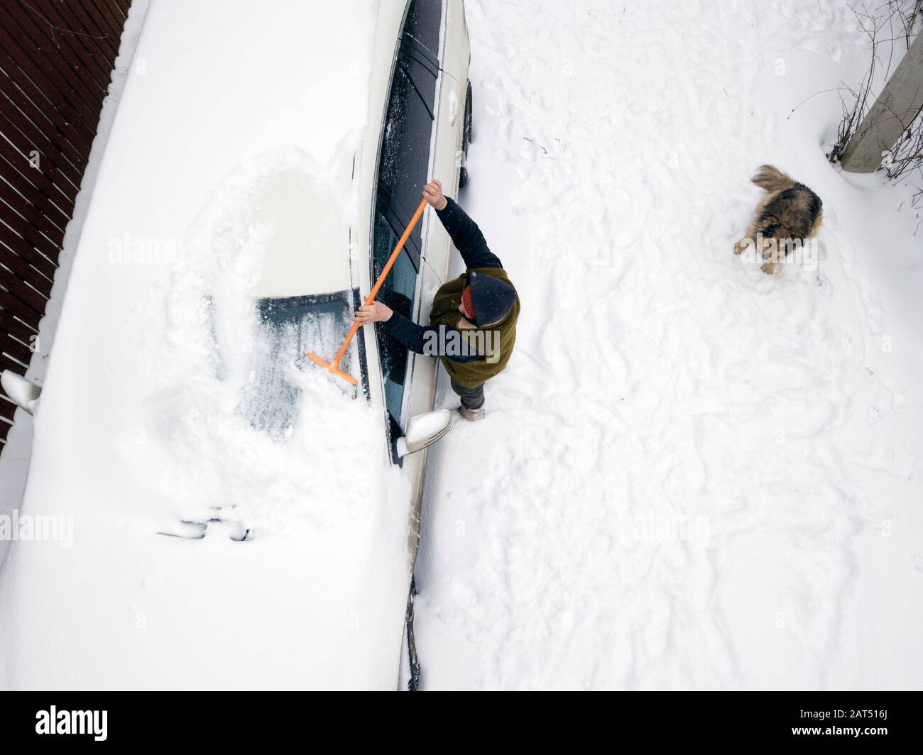 Woman removing snow from vehicle hi-res stock photography and images ...