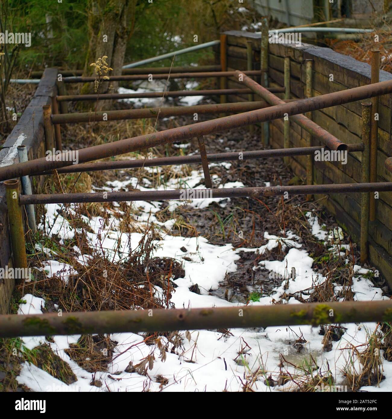 Trench with metal pipes in the messy backyard, winter scene Stock Photo ...