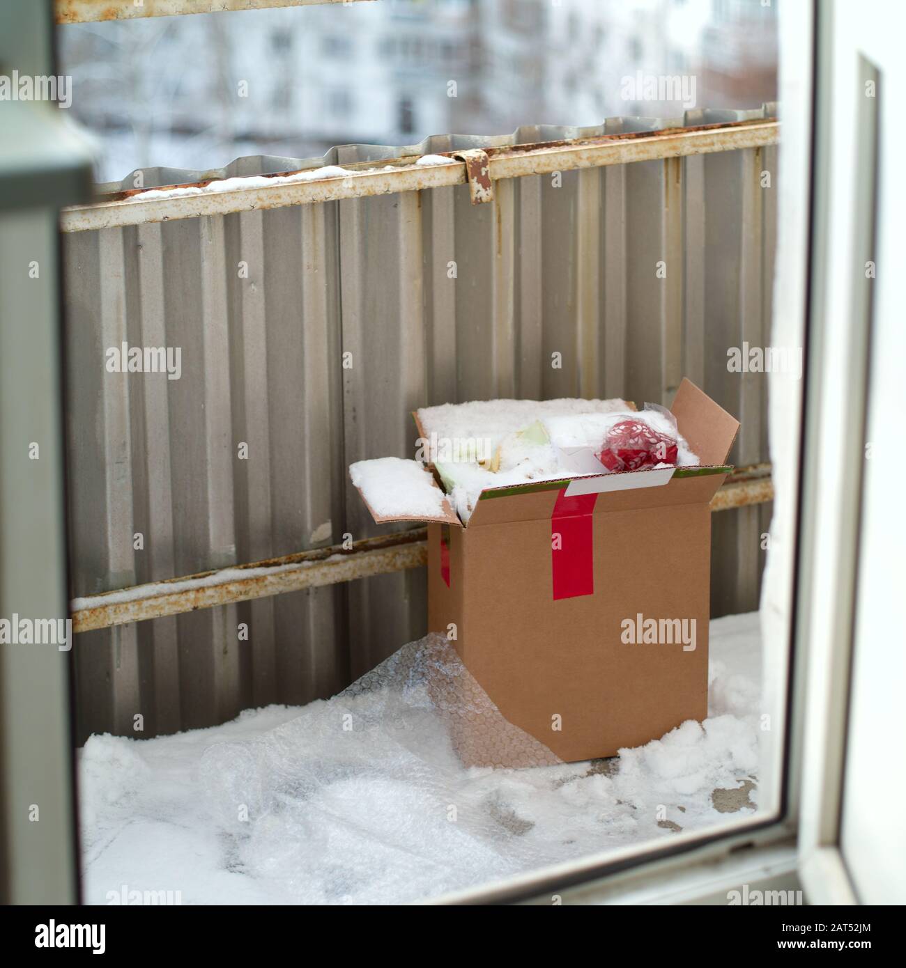 A cardboard box full of garbage abandoned on a balcony Stock Photo - Alamy