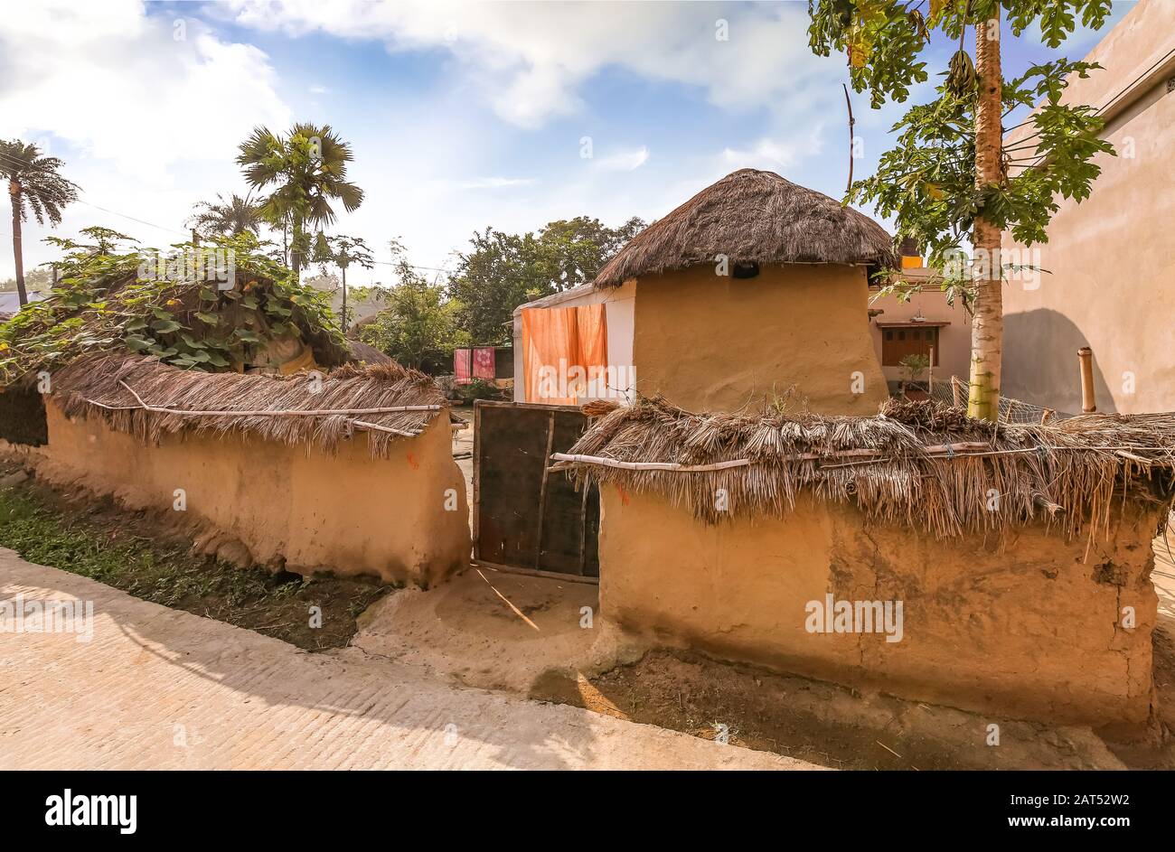 Rural Indian village with view of mud hut with thatched roof at Bolpur ...