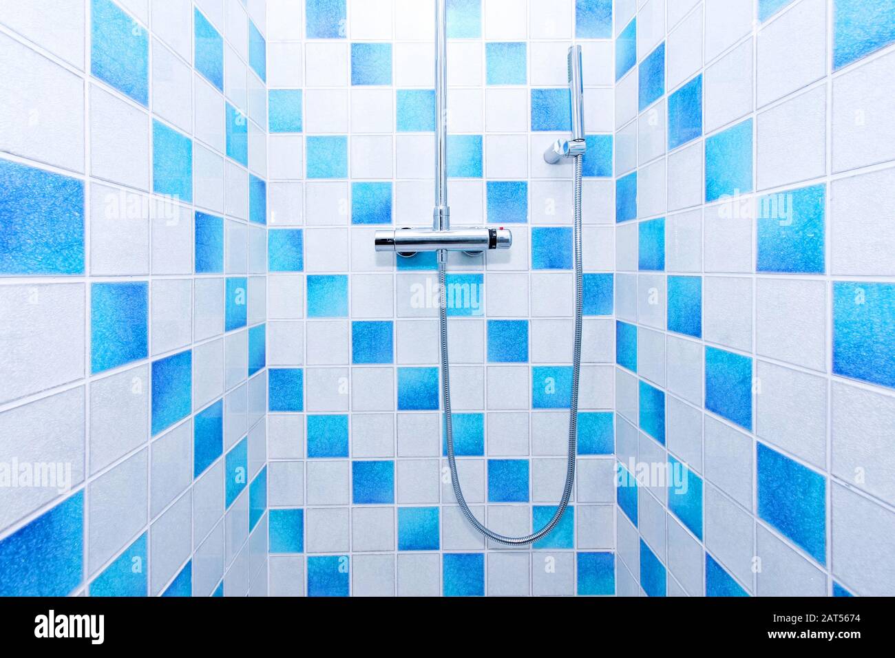 Inside of shower with blue and white tiles Stock Photo - Alamy