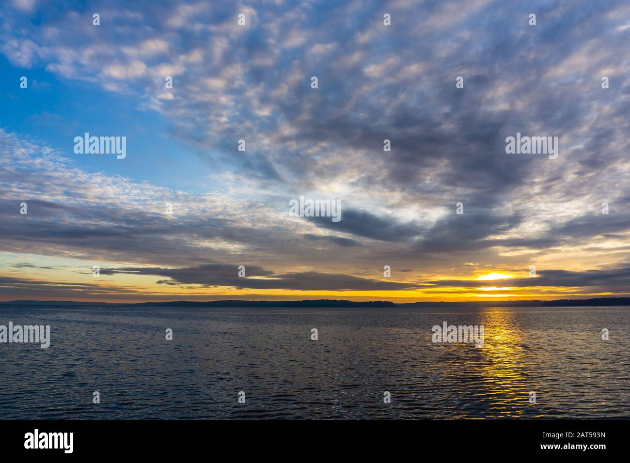 An overcast cloudy sunset over the Puget Sound in West Seattle ...