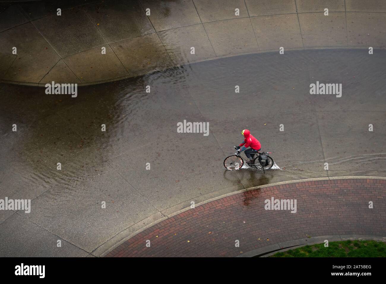 Bicycling in the Rain. A downpour floods a Vancouver street as a ...