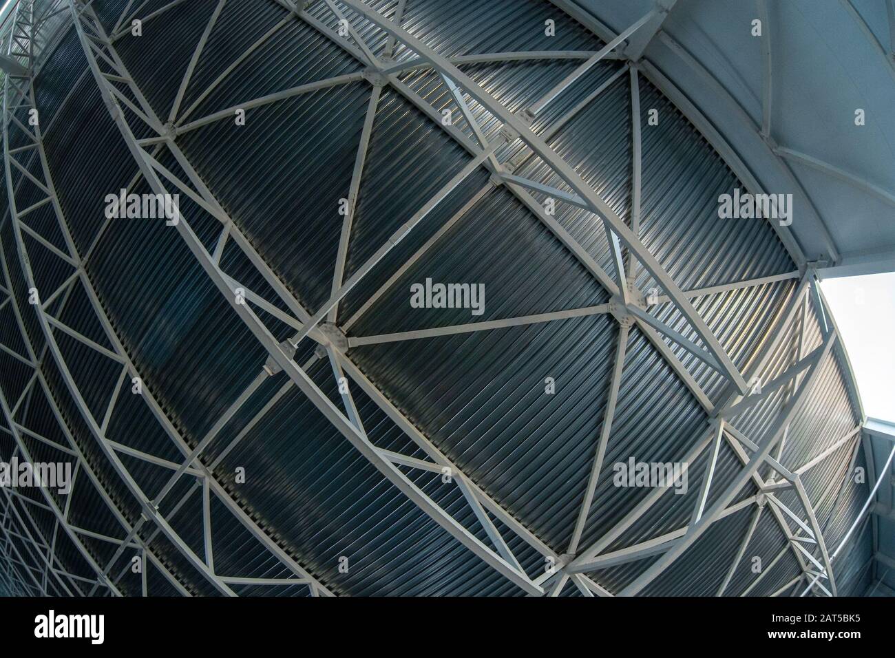 A heavy distortrd fish-eye lens picture of industrial ceiling with ...