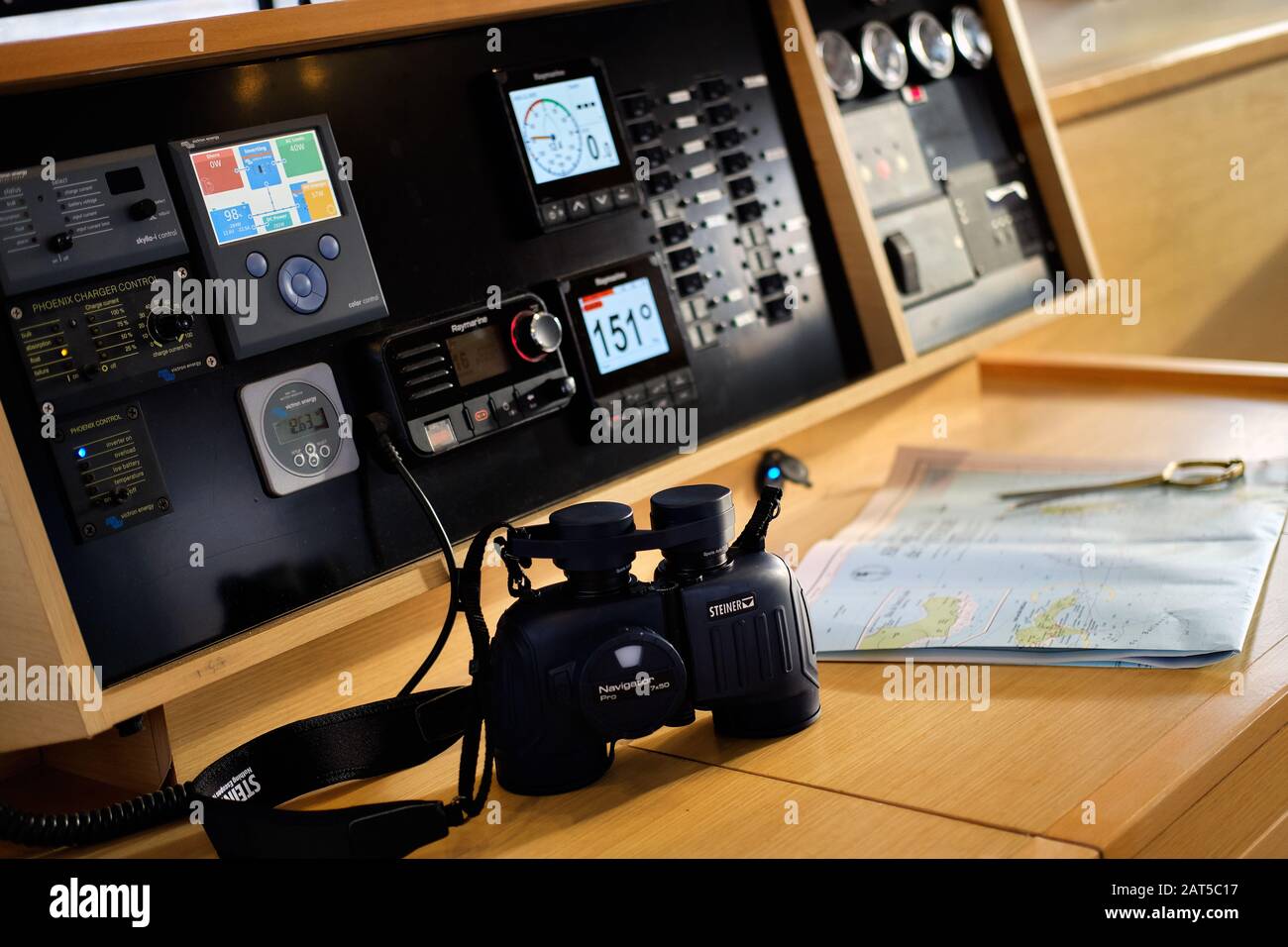 Close up image of binocular and paper map lie on wooden board, view to ...