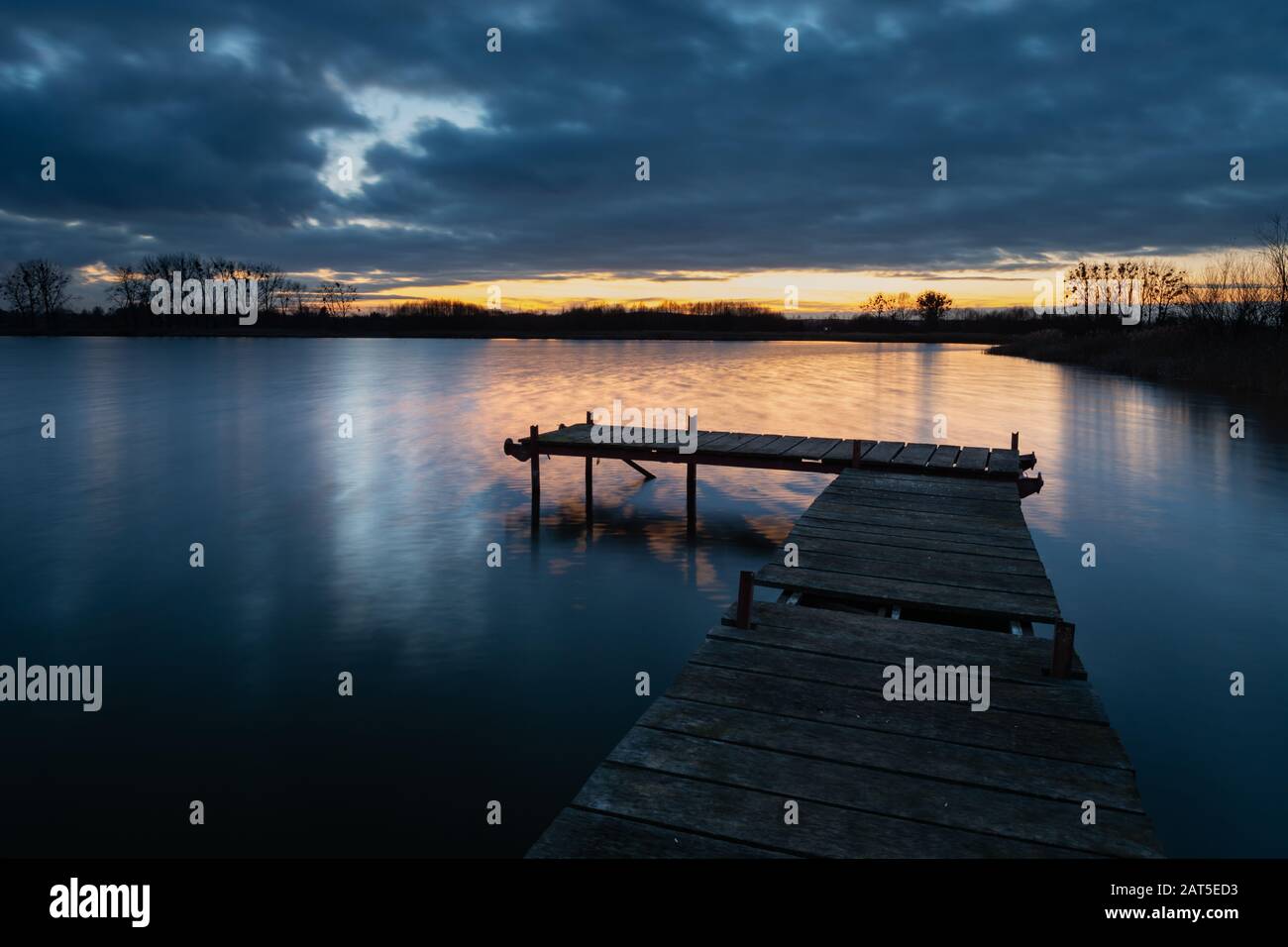 Wooden deck bridge and evening clouds after sunset over the water Stock ...