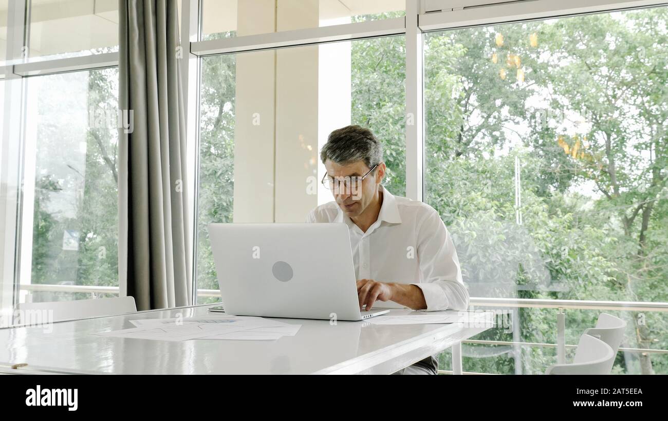 Male businessman in the office at work Stock Photo - Alamy