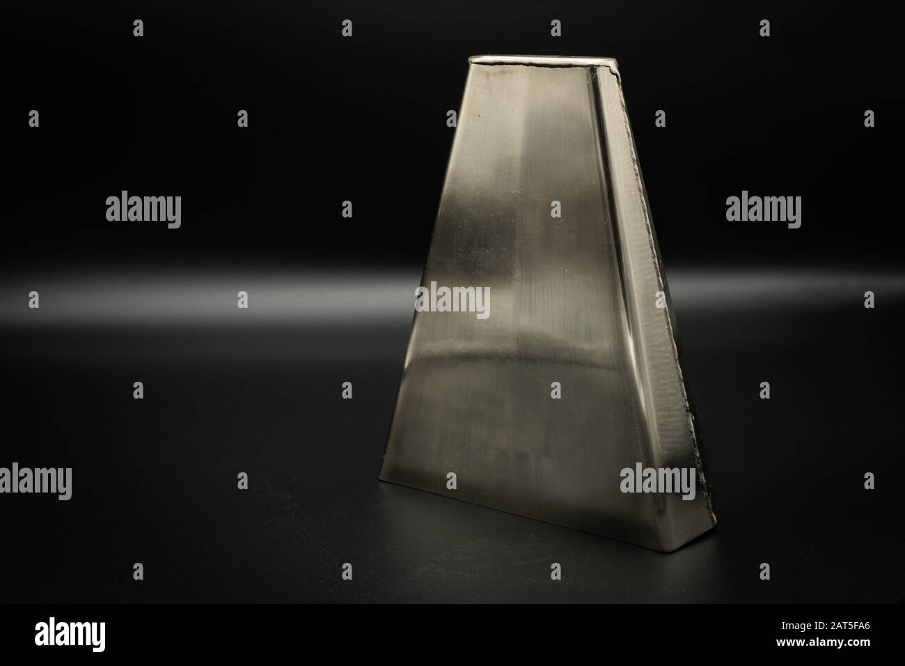 Closeup of a bongo bell standing on a black background Stock Photo - Alamy