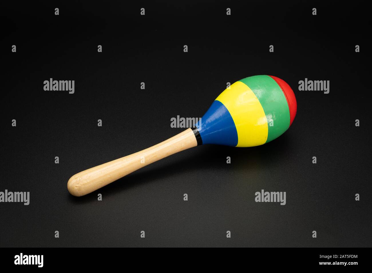 Closeup of a colorful maracas lying on a black underground Stock Photo ...