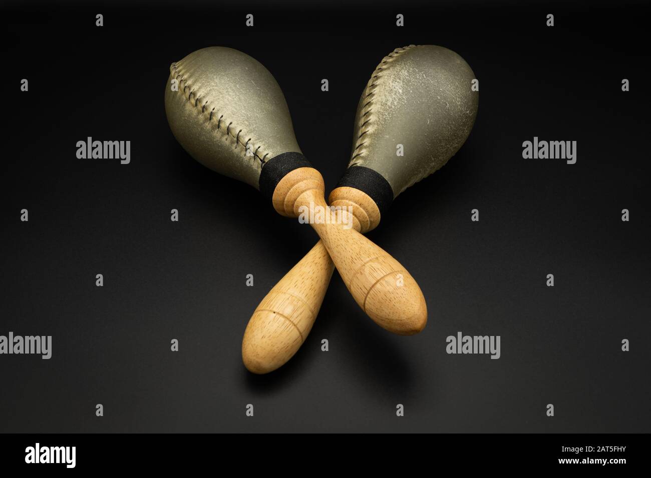 Closeup of a pair of rawhide maracas lying on a black underground Stock ...