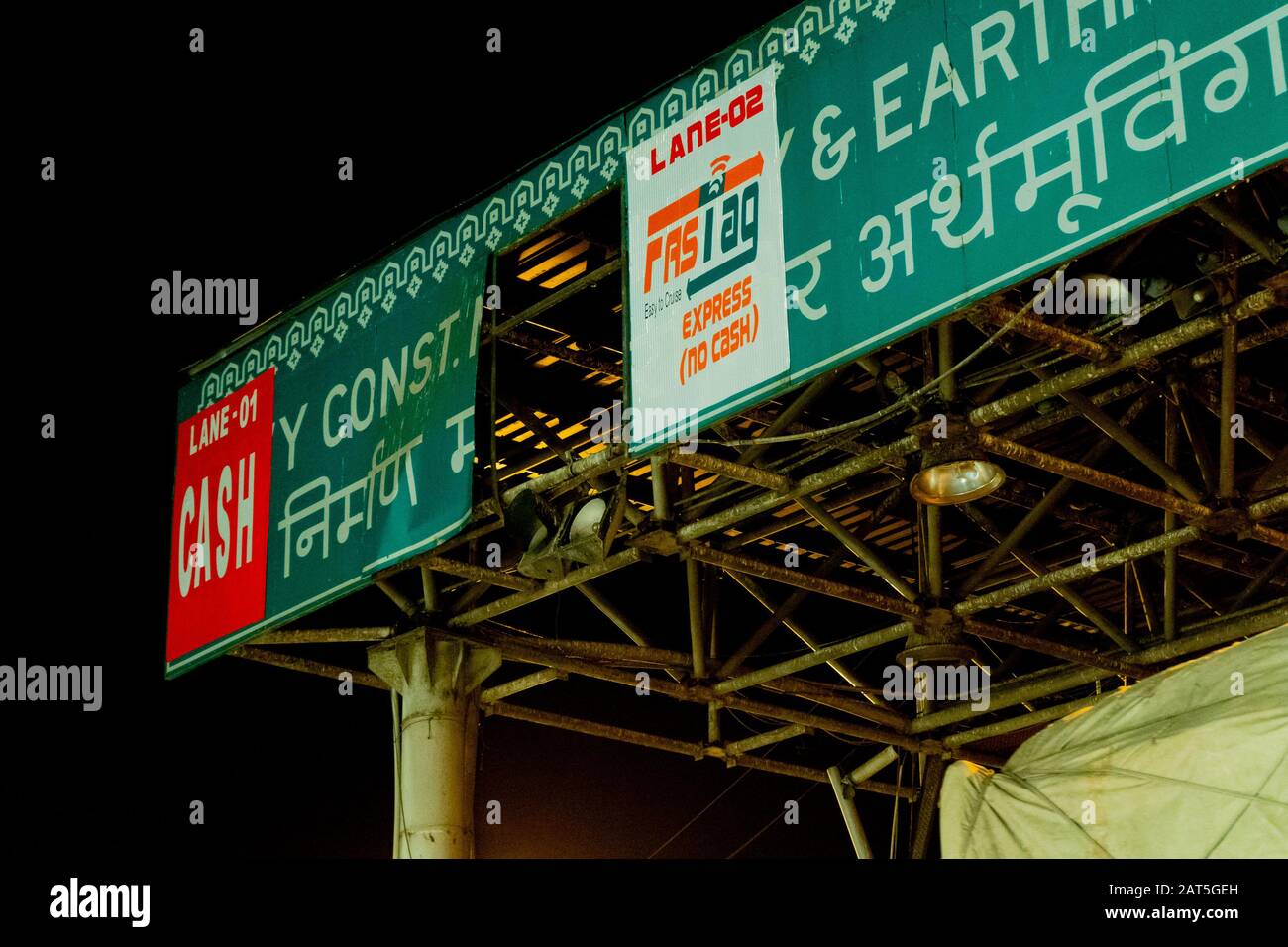 Green head board of NHAI toll booth with sticker for Fastag and cash ...