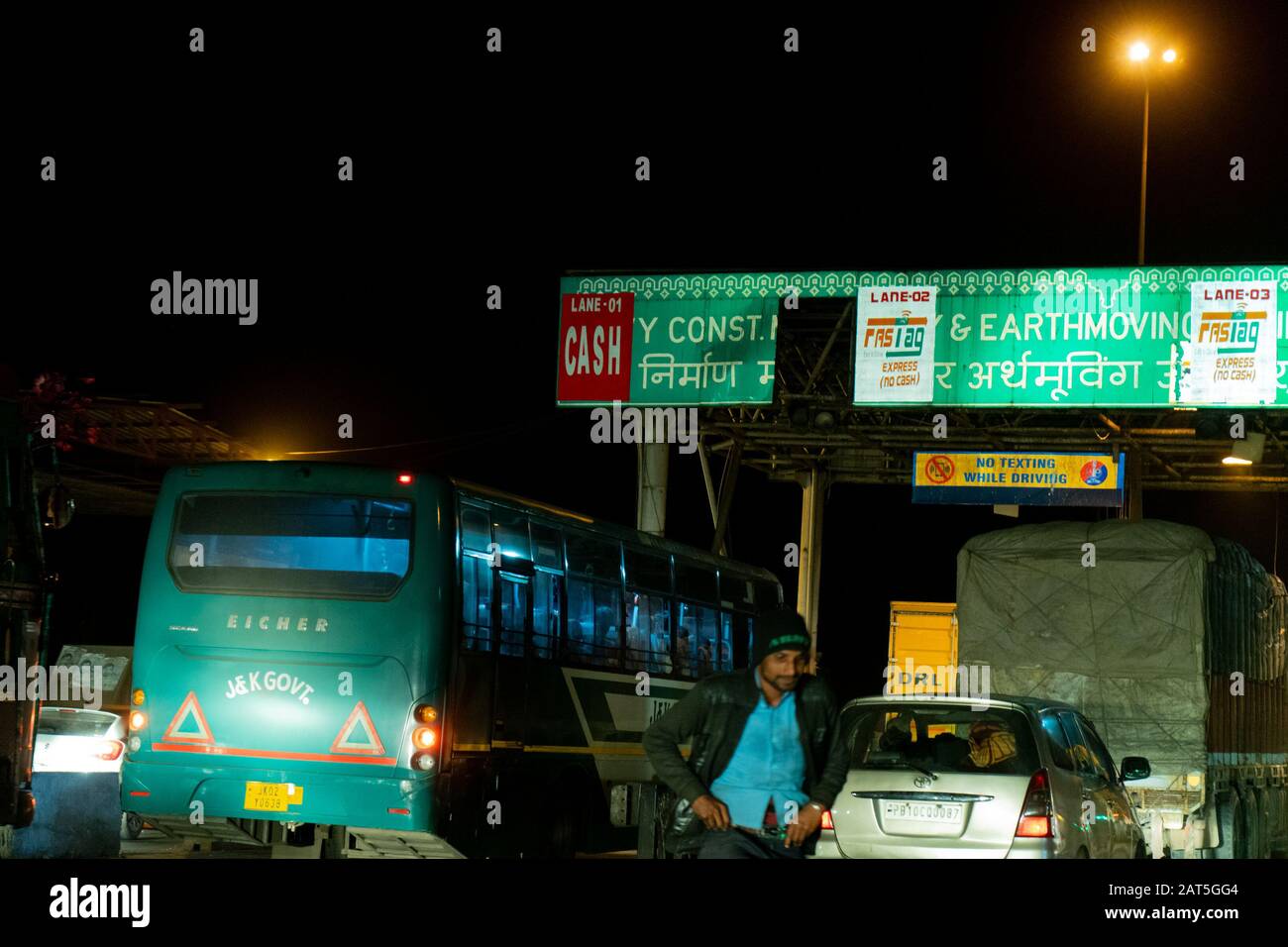 Green head board of NHAI toll booth with sticker for Fastag and cash ...
