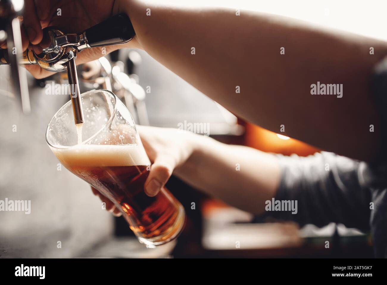 Light Draft cold beer pour in glass from crane in pub Stock Photo - Alamy