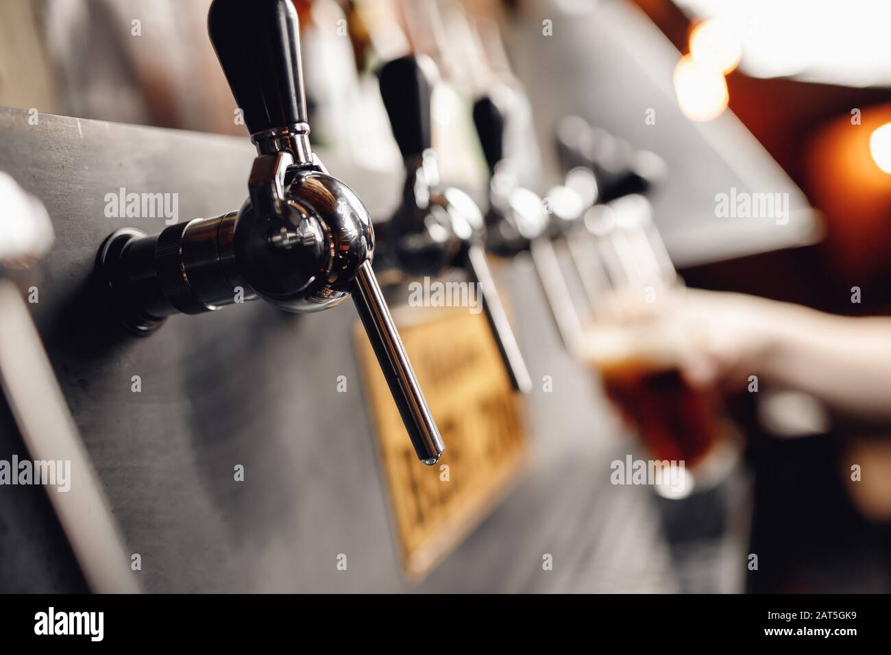 Light Draft cold beer pour in glass from crane in pub Stock Photo - Alamy