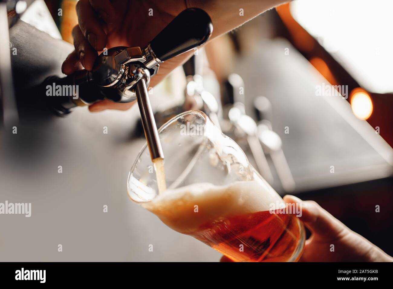 Light Draft cold beer pour in glass from crane in pub Stock Photo - Alamy