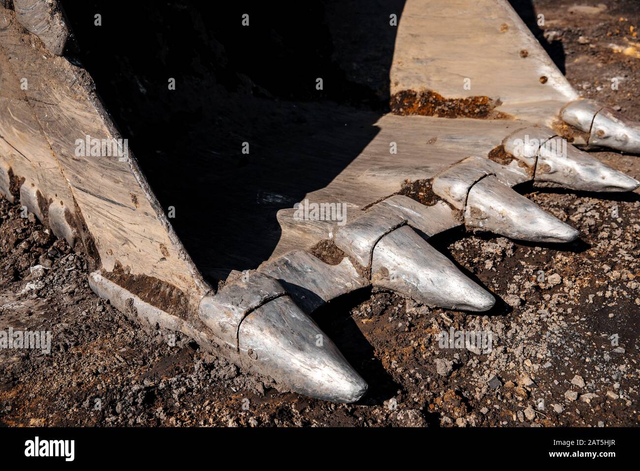 Close up of iron teeth loader excavator bucket with parts of soil Stock ...