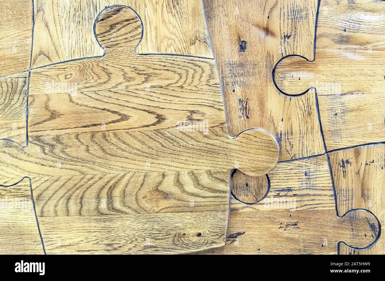 Wooden puzzles. Puzzles from a parquet board Stock Photo - Alamy