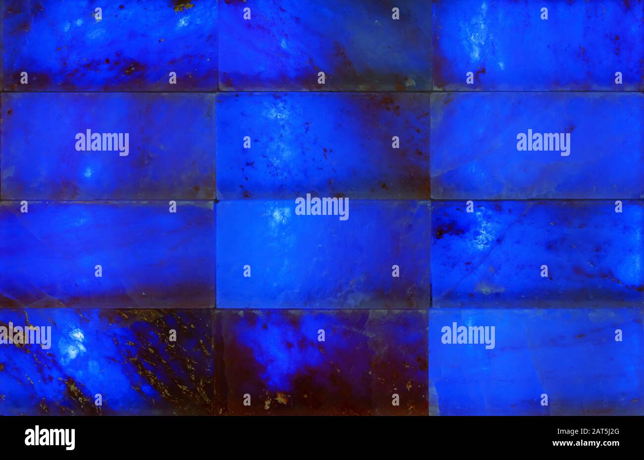 Texture of natural quartz stone with blue backlight. Blocks from ...