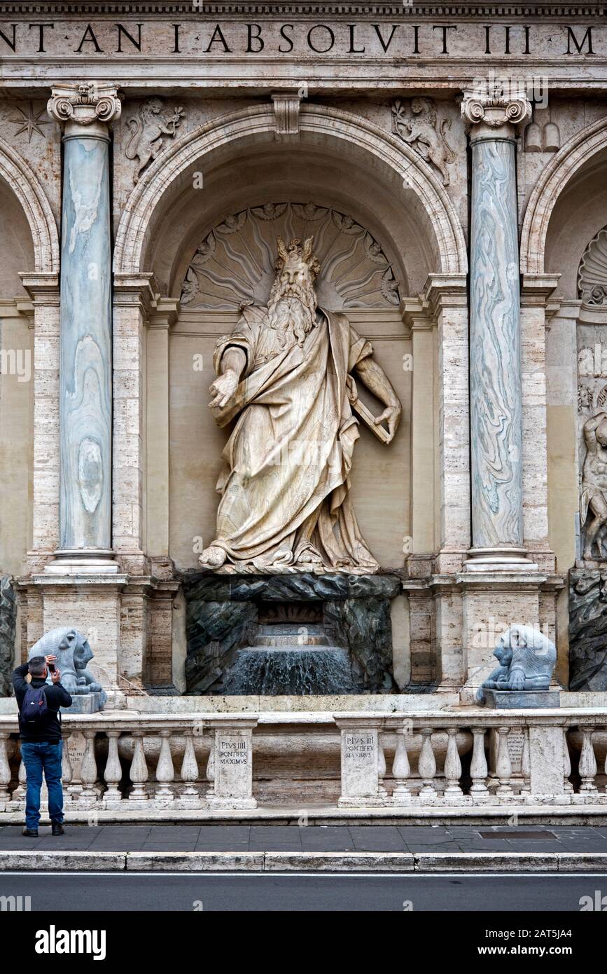 Tourist photographing the Fontana dell'Acqua Felice or Moses Fountain ...