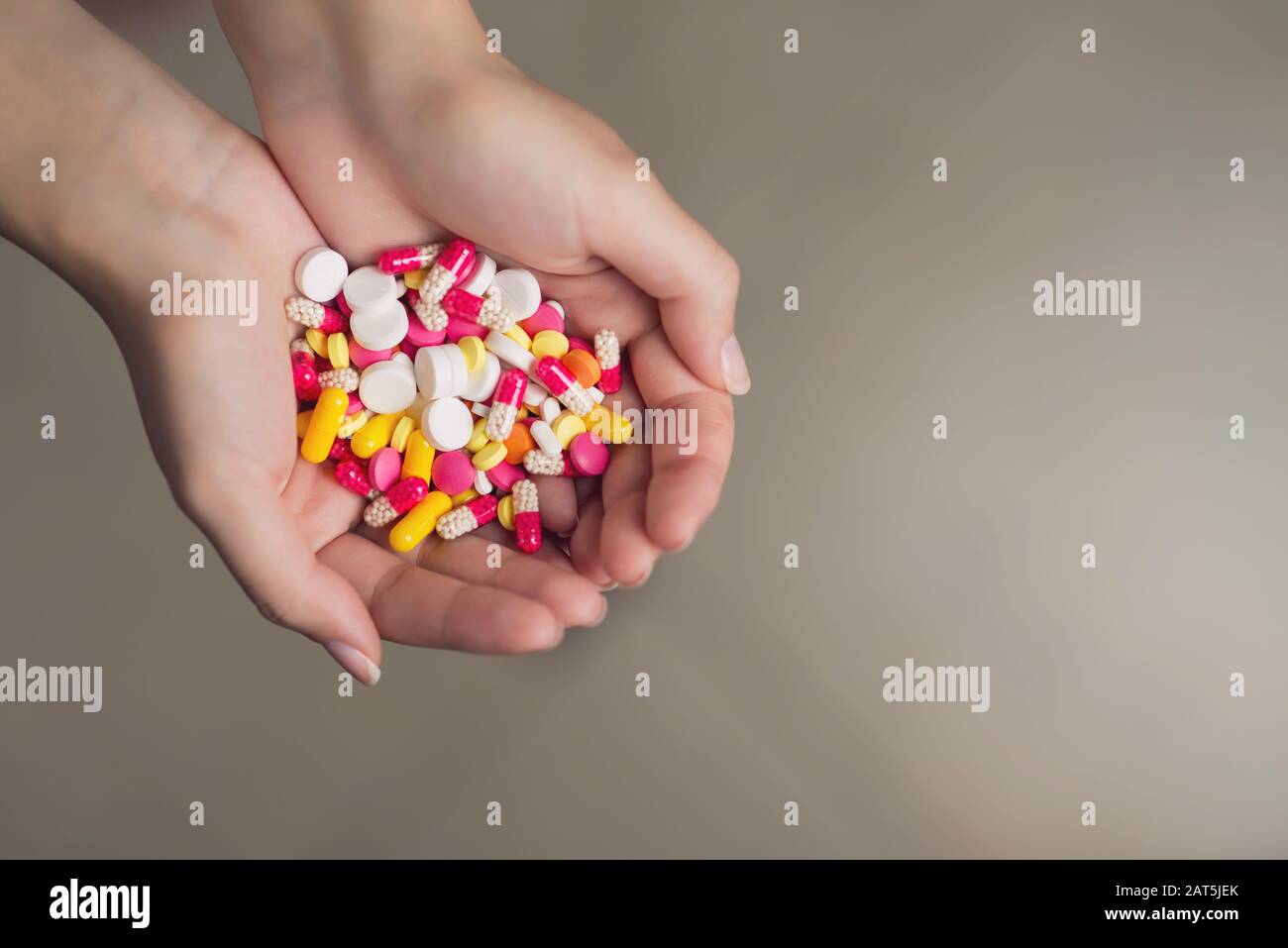 a handful of tablets of different colors in female hands Stock Photo ...