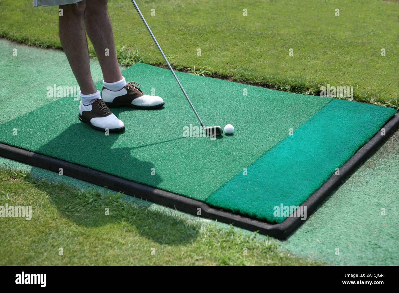 summer day with man hiting a golf ball at the driving range Stock Photo ...