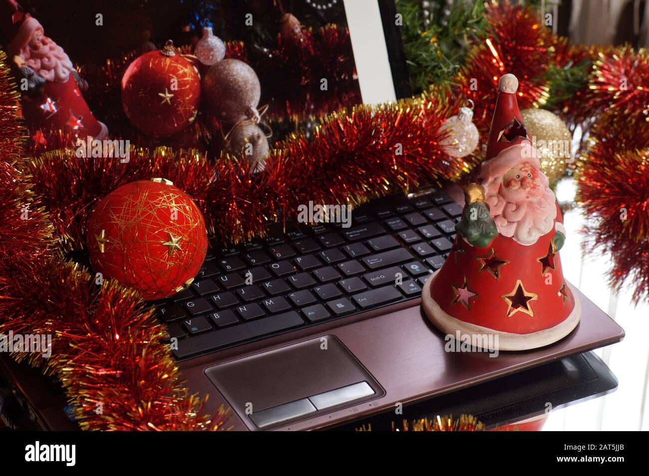 Christmas decorations. Christmas gift under the Christmas tree: laptop ...