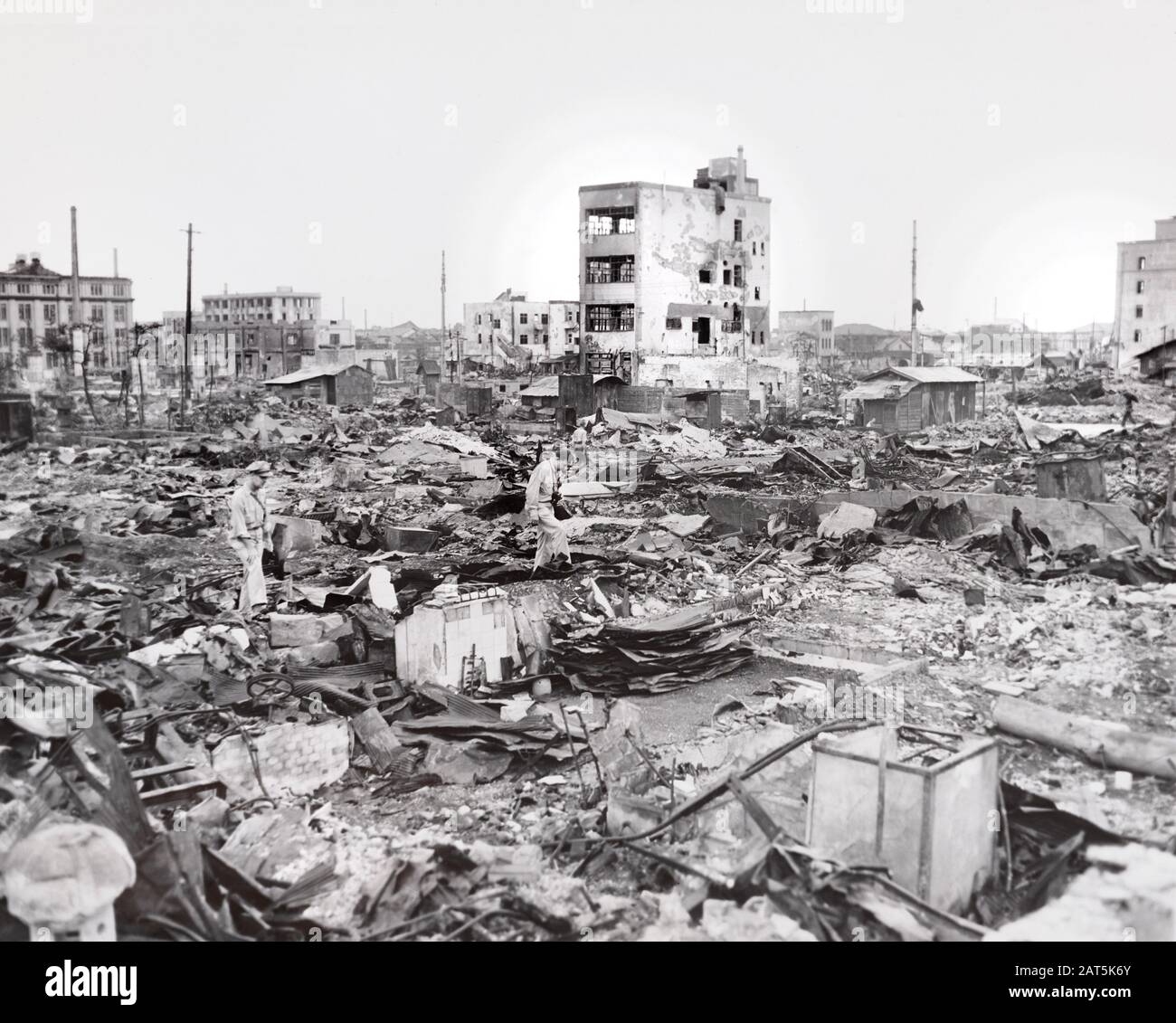 Two People Walking Amongst Debris after Bombing by U.S. Air Force ...